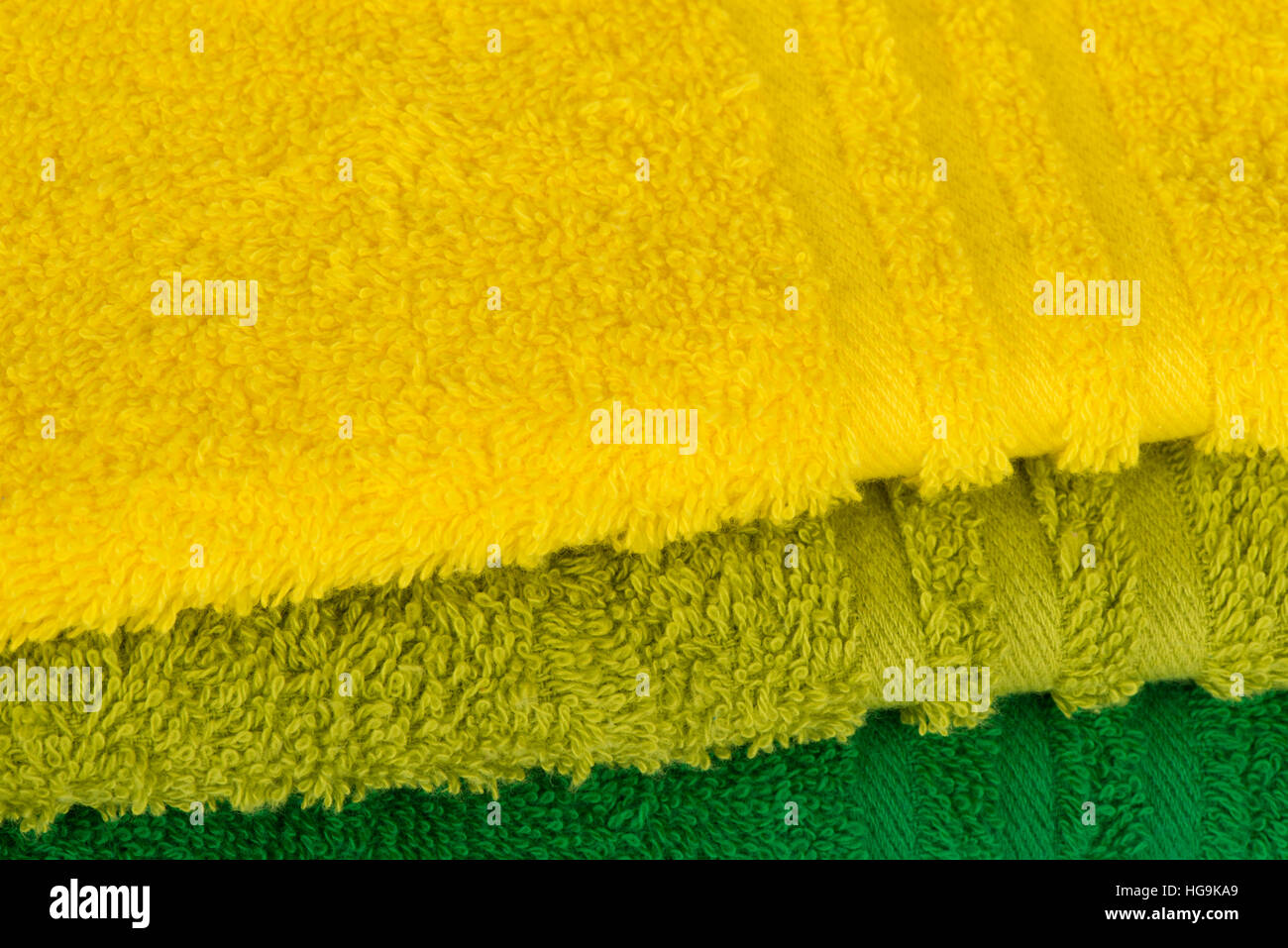 Stack of beautiful colored bath towels in a green, blue, yellow color ...
