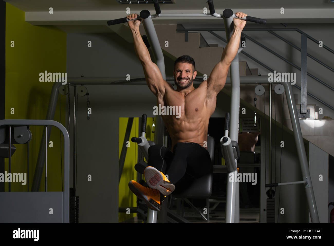 Muscular Man Performing Hanging Leg Raises Exercise - One Of The Most ...