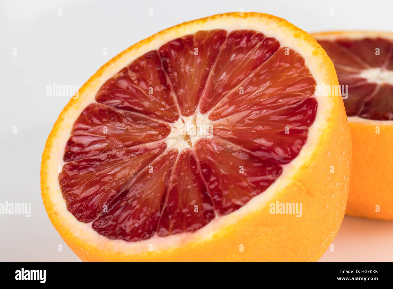 Cut blood orange on a white background Stock Photo - Alamy