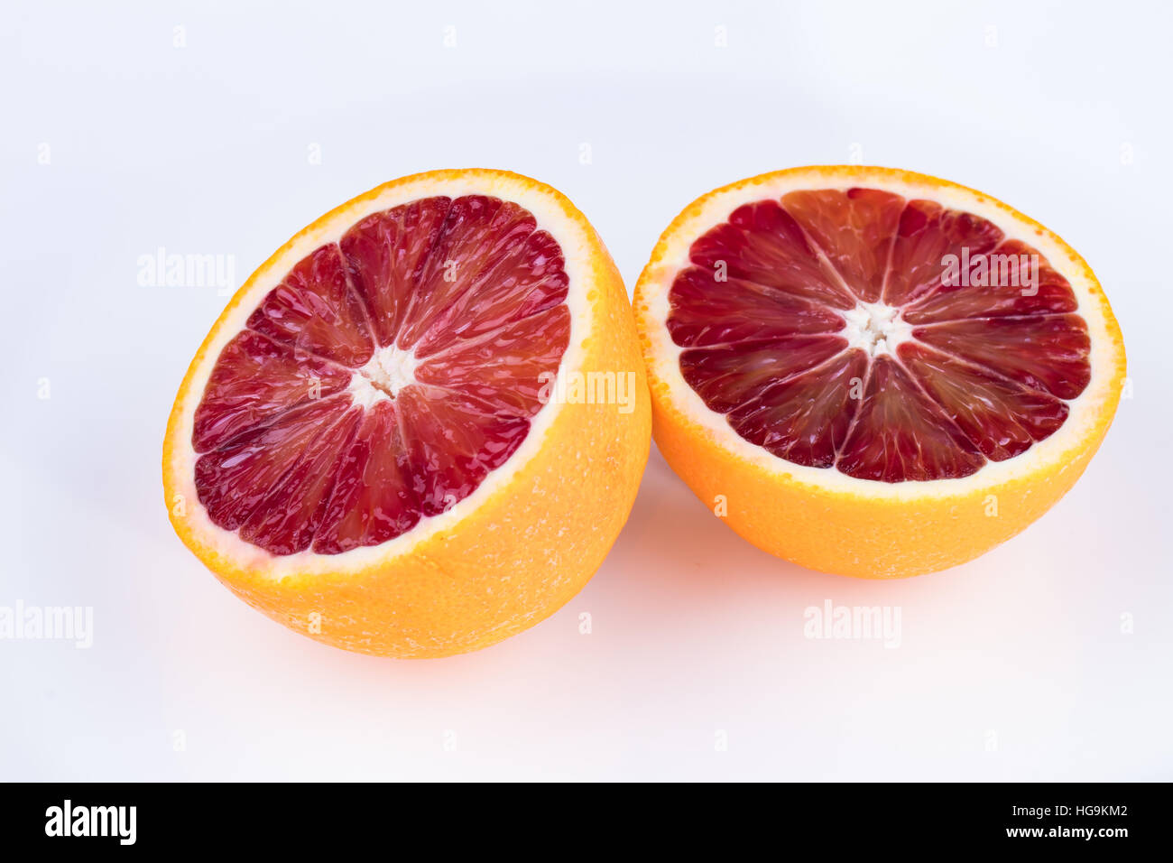 Cut blood orange on a white background Stock Photo - Alamy
