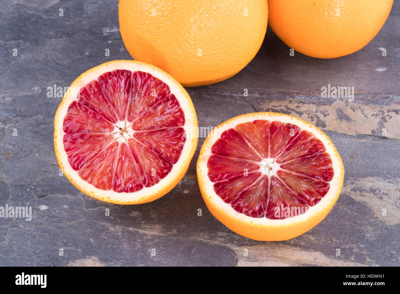 Blood oranges on gray slate Stock Photo - Alamy