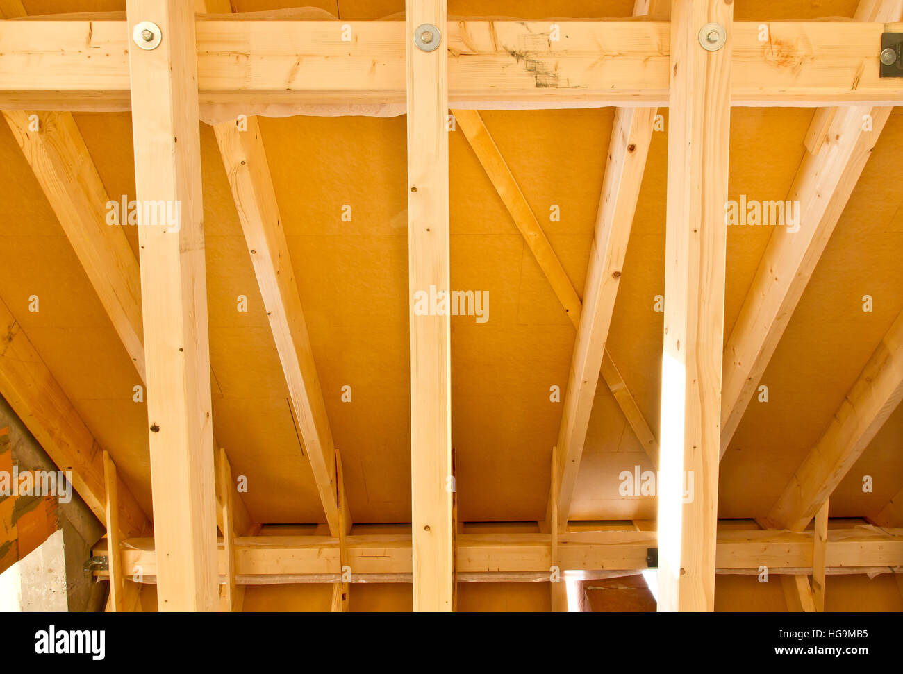 Indoor image of a wooden frame roof truss construction on a new house ...