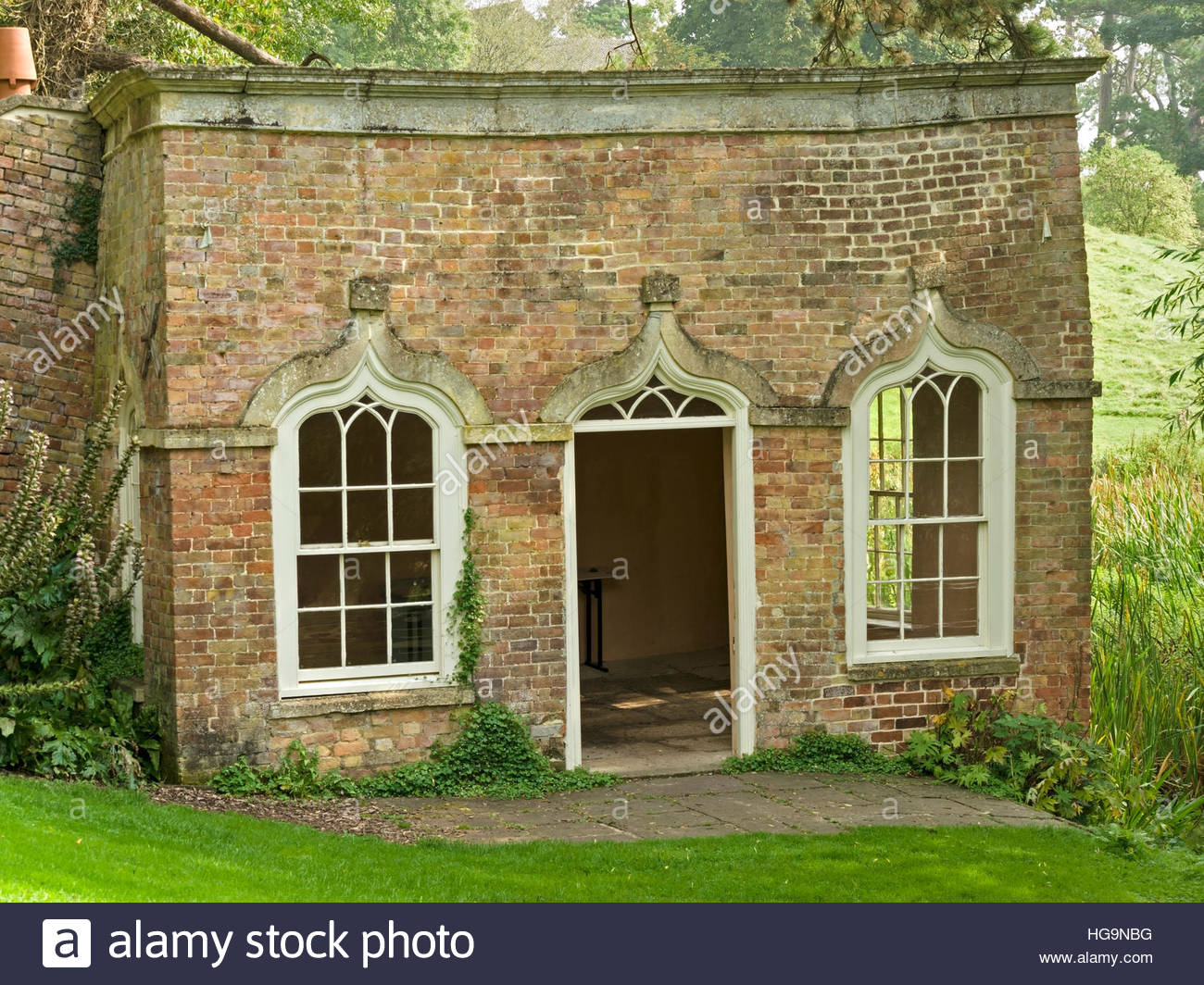 Ornate brick summerhouse with Ogee arched windows and doorway in Stock ...