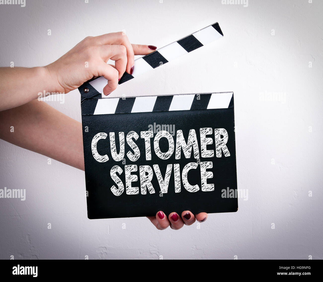 Customer Service. Female hands holding movie clapper Stock Photo - Alamy