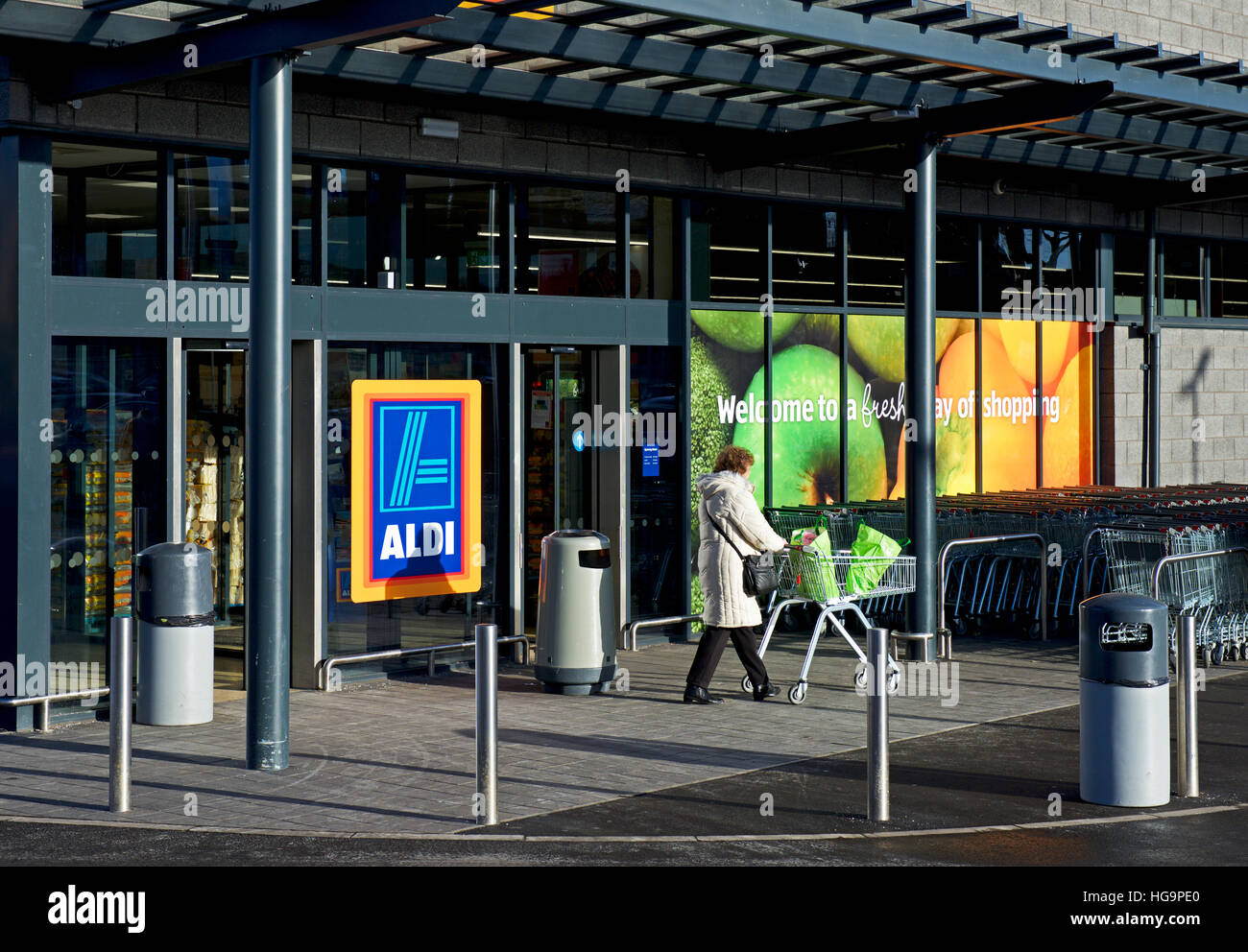 Woman outside Aldi supermarket, England UK Stock Photo - Alamy