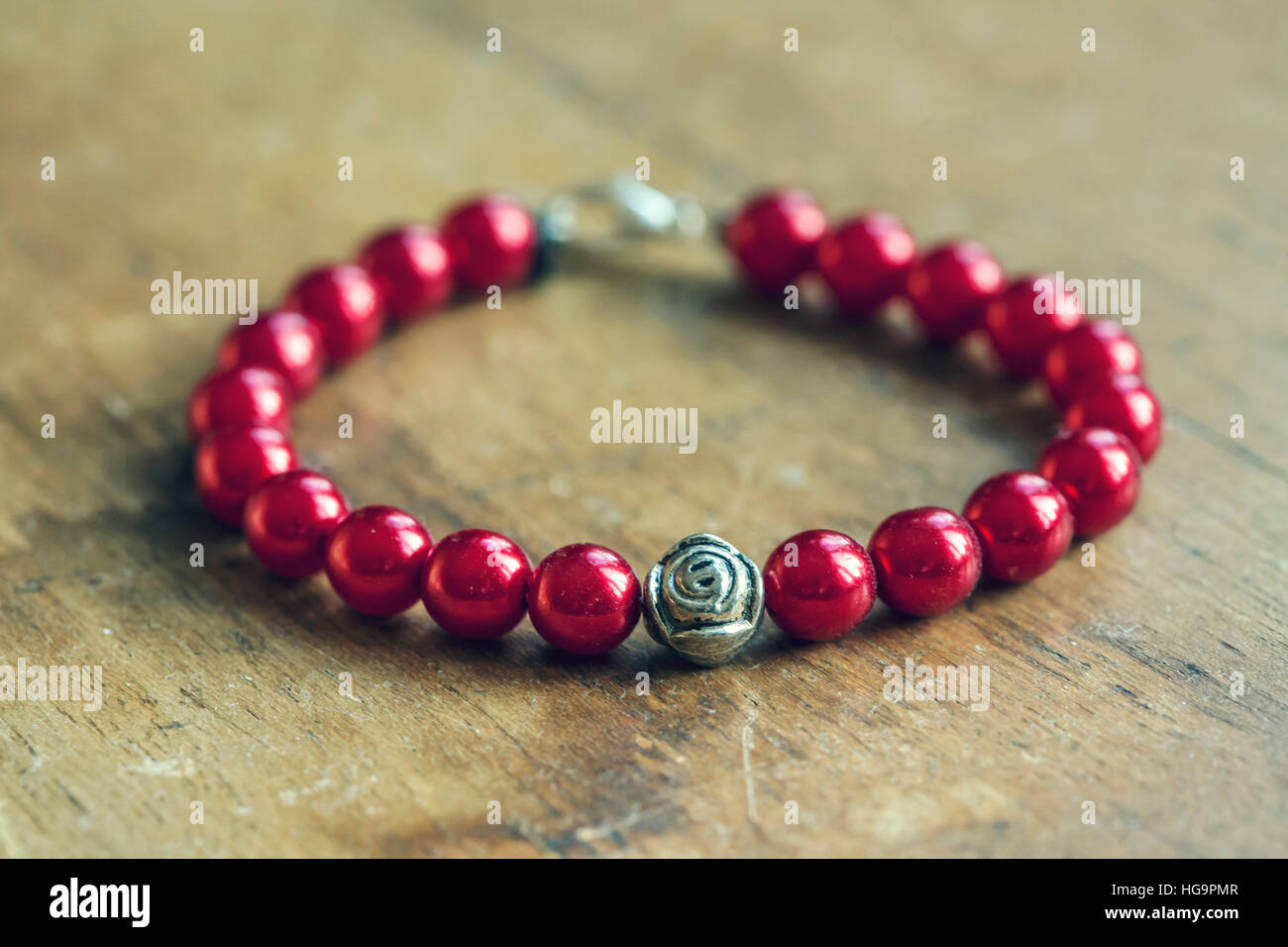 Beautiful bracelet on vintage wooden table Stock Photo - Alamy