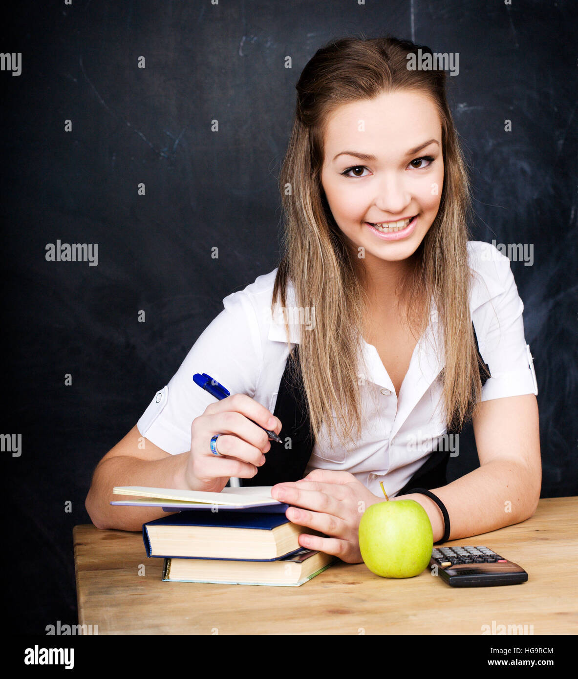 portrait of happy cute student with book in classroom Stock Photo - Alamy