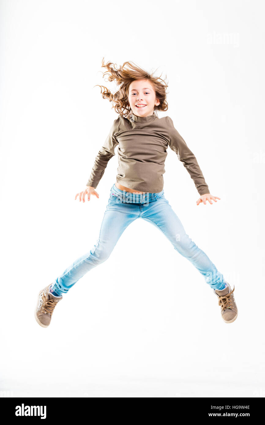 jumping girl seems to fly isolated on white background Stock Photo - Alamy