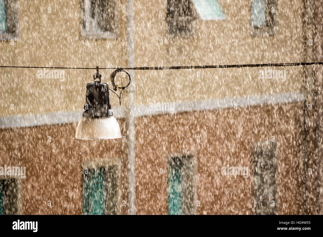 suspension street lamp under rain and direct sunlight Stock Photo - Alamy