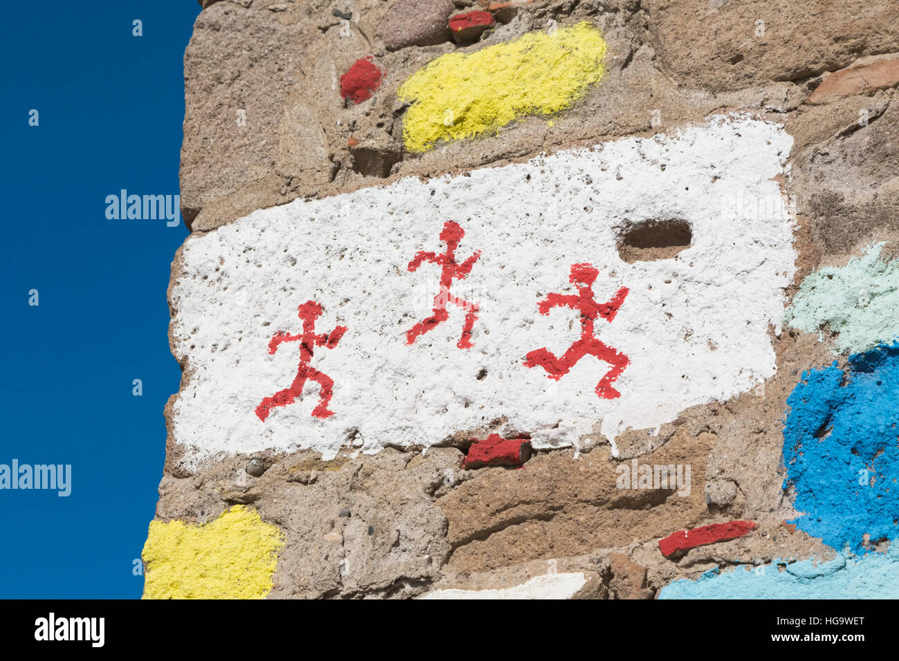 Graffiti in Bergama, Izmir Province, Turkey. Three red running figures ...