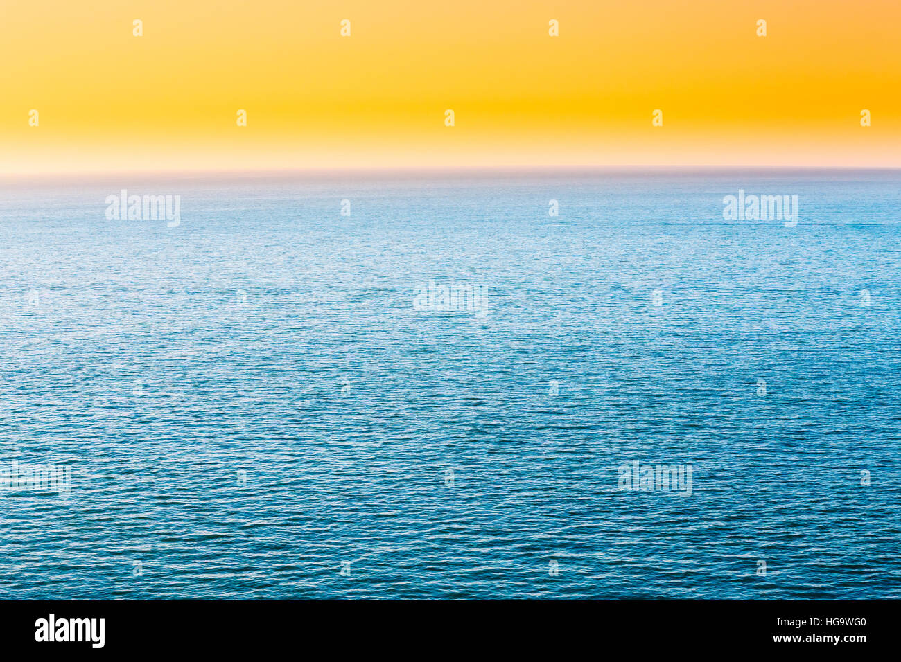 Calm Blue Sea Or Ocean And Yellow Clear Sunset Or Sunrise Sky ...