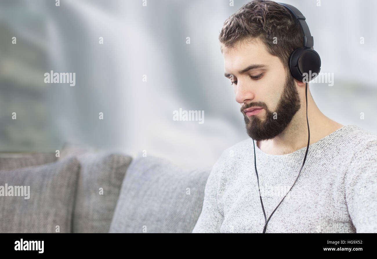 Man listening relaxation music by headset in nature at waterfall Stock ...