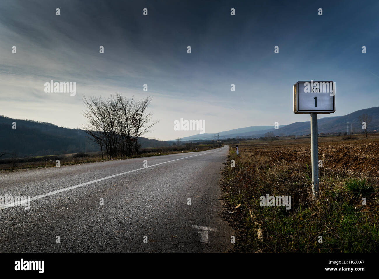 One kilometer sign on a country deserted road Stock Photo - Alamy