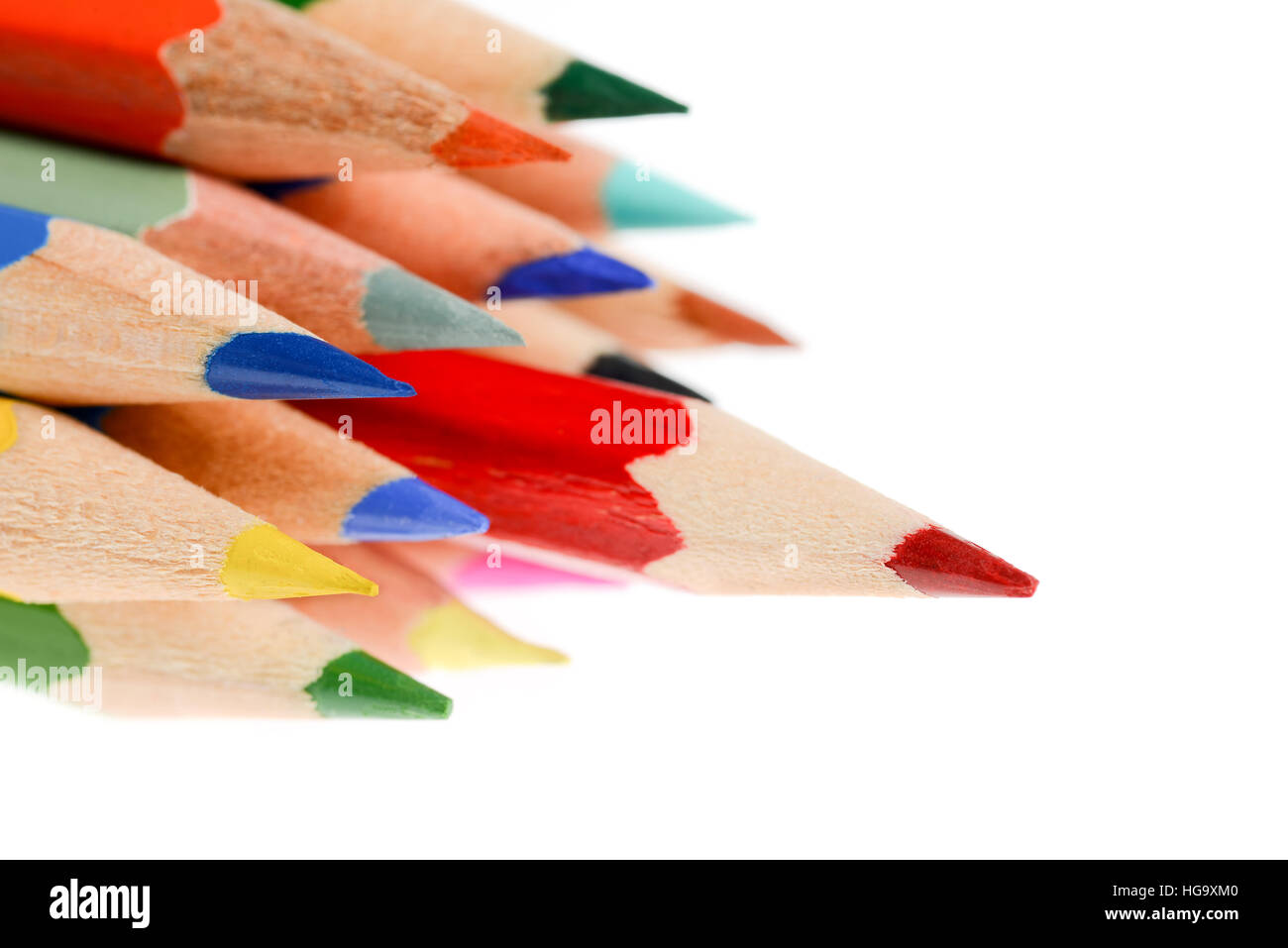 The peaks of crayons arranged on the table Stock Photo - Alamy
