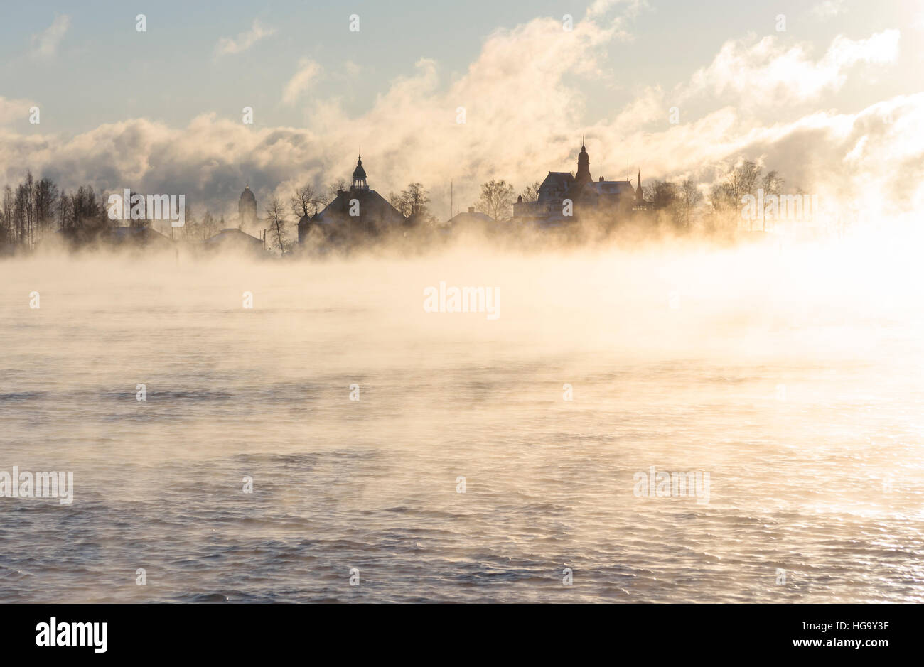 Island with buildings in a steaming ocean Stock Photo - Alamy