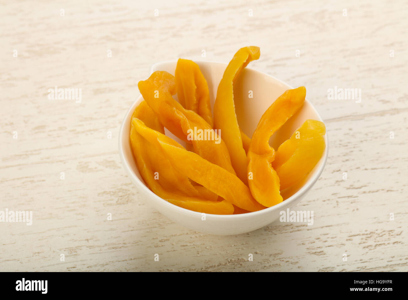 Dry mango chips heap in the bowl Stock Photo - Alamy