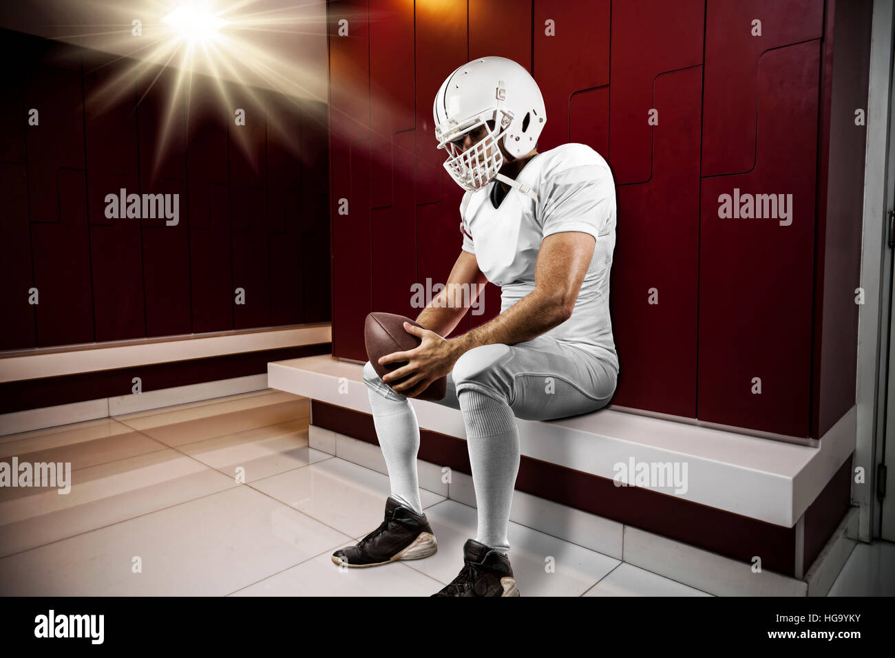 Football Player with a white uniform seated in locker room Stock Photo ...
