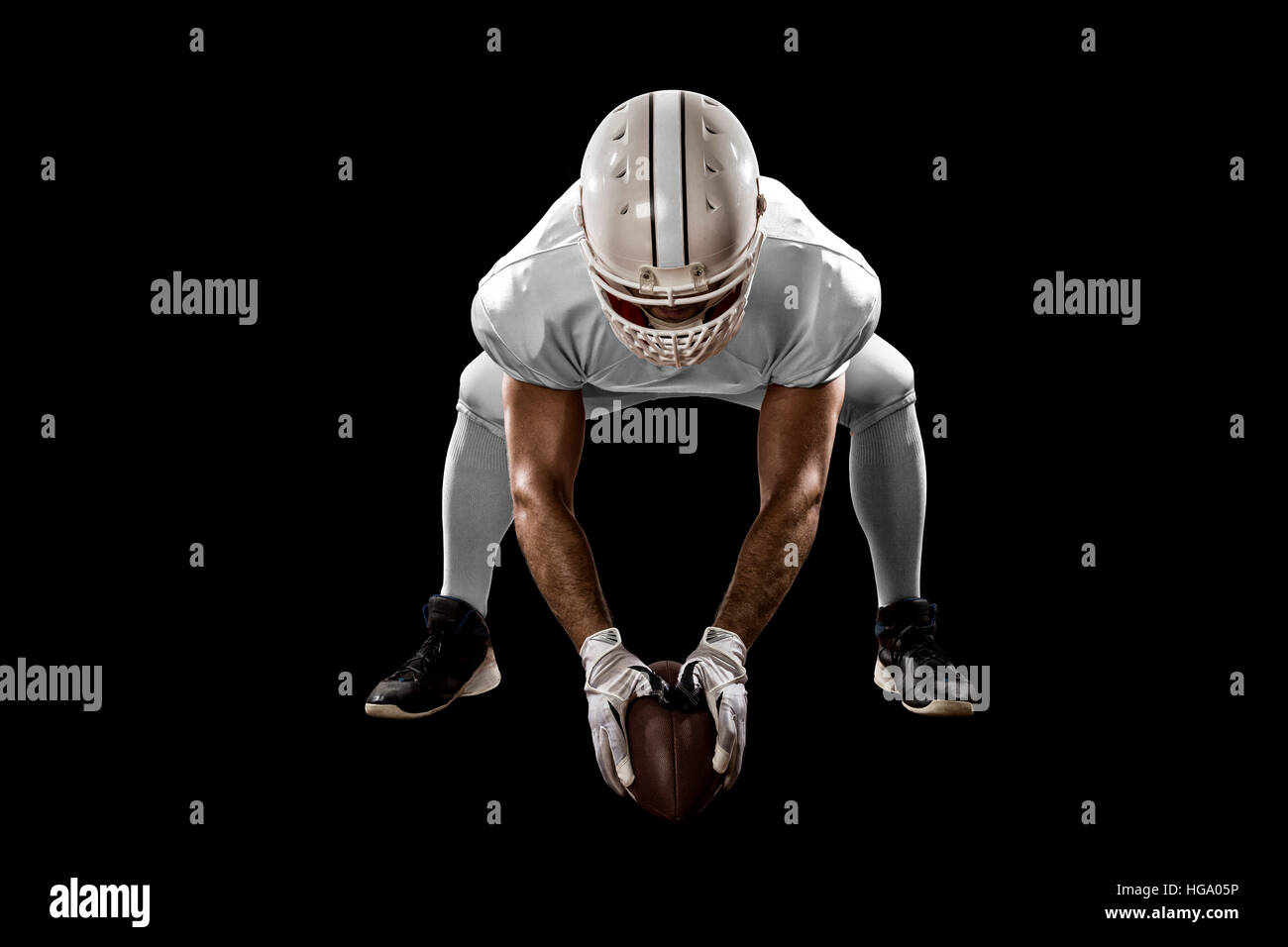 Football Player with a white uniform on the scrimmage line, on a black ...