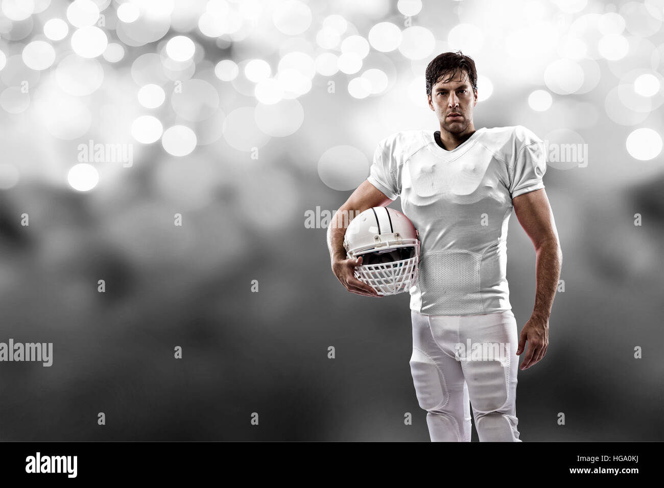 Football Player with a white uniform on a white lights background Stock ...