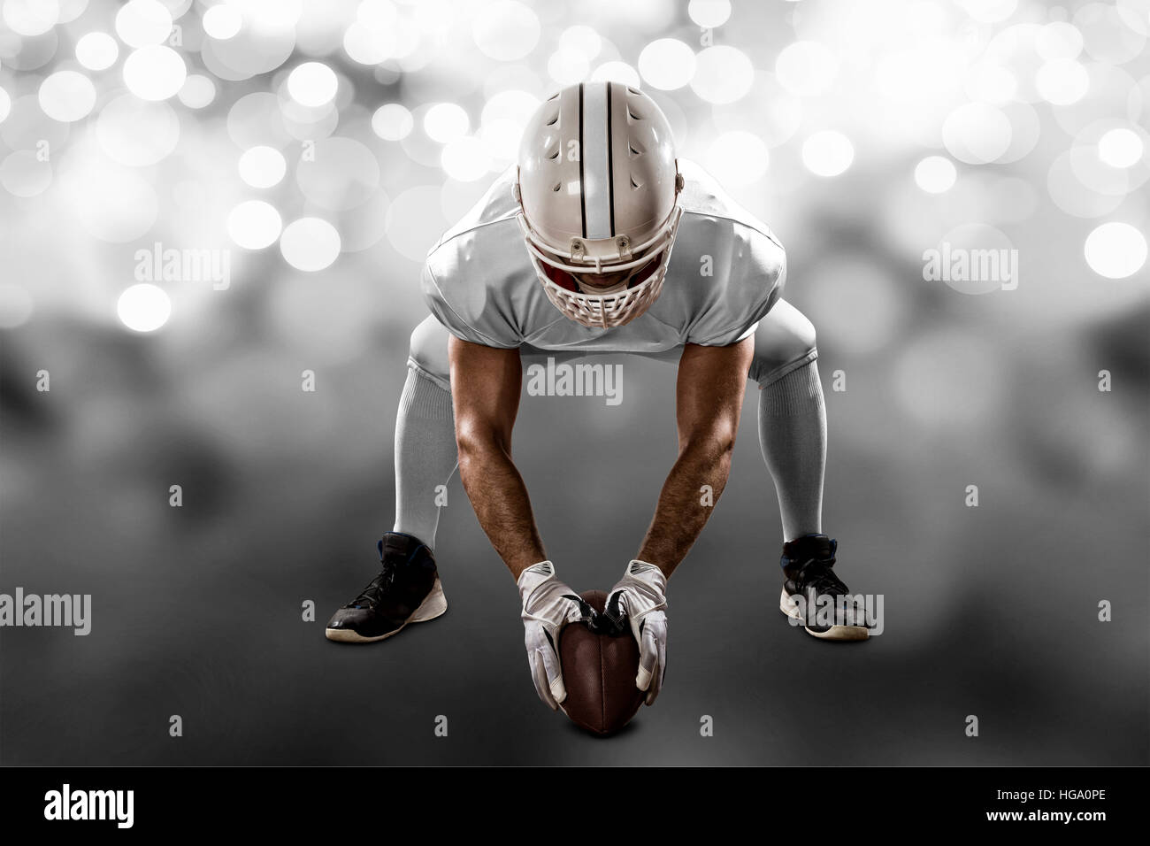 Football Player with a white uniform on the scrimmage line, on a white ...