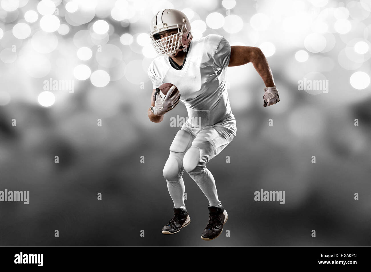 Football Player with a white uniform Running on a white lights ...
