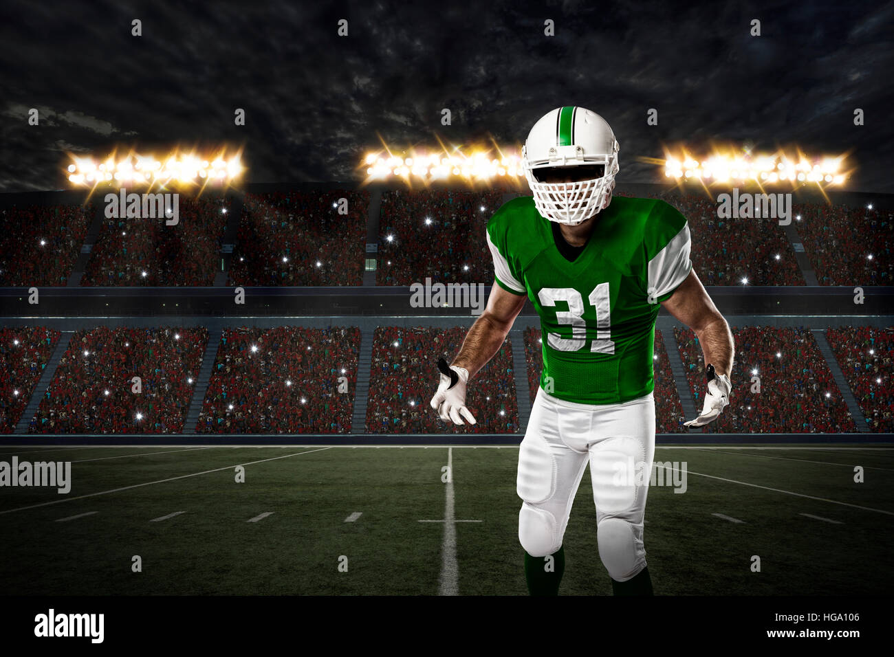 Football Player with a green uniform on a stadium Stock Photo - Alamy