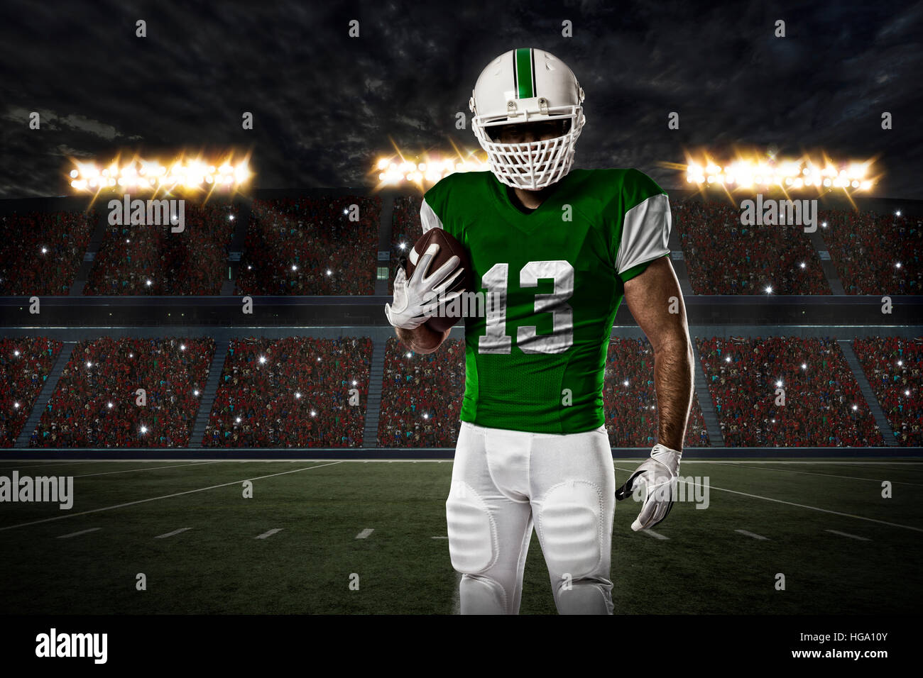 Football Player with a green uniform on a stadium Stock Photo - Alamy