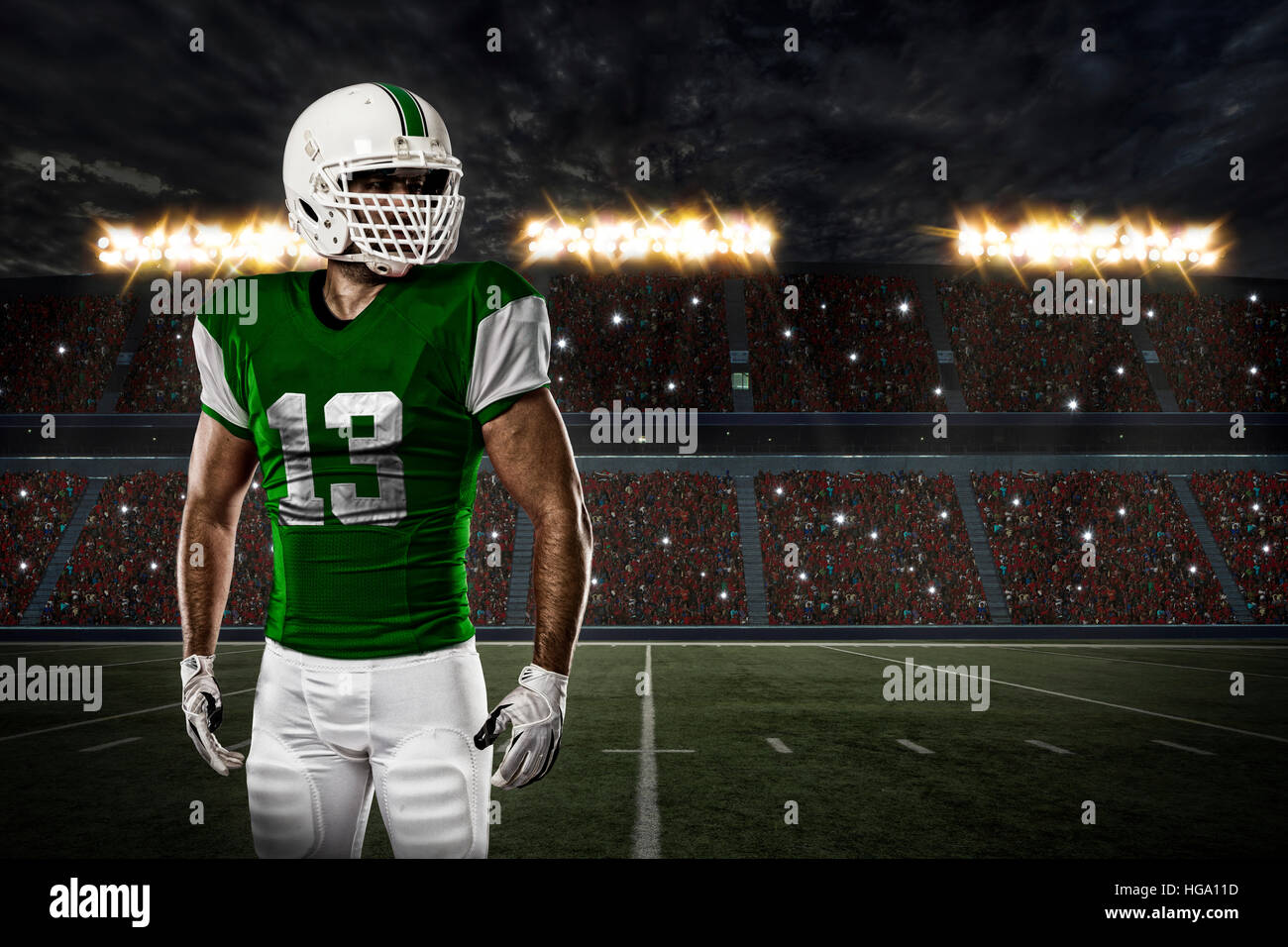 Football Player with a green uniform on a stadium Stock Photo - Alamy