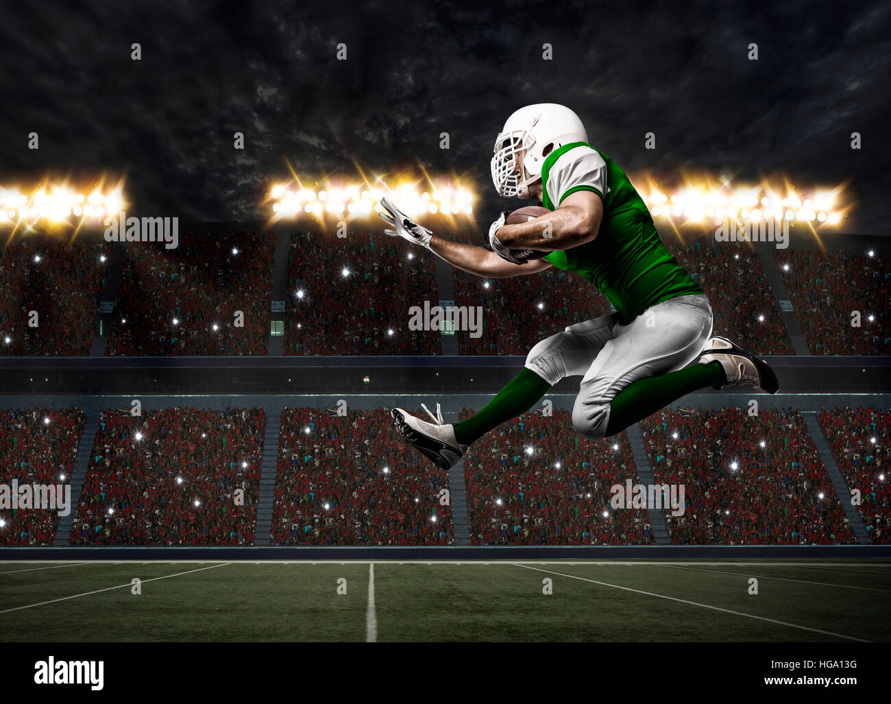 Football Player with a green uniform running on a stadium Stock Photo ...