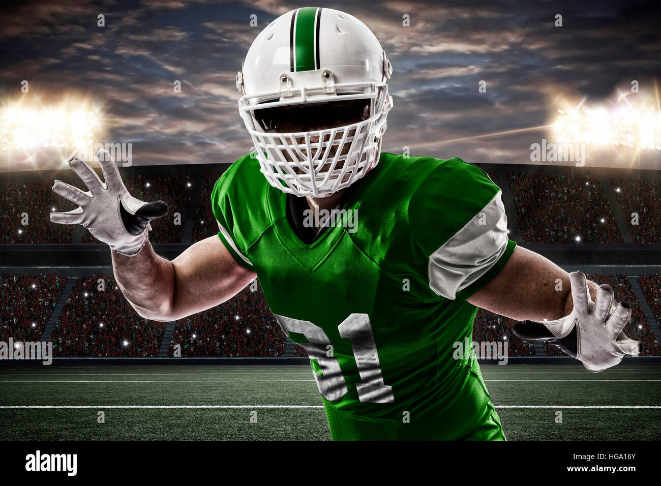 Football Player with a green uniform making a tackle on a stadium Stock ...