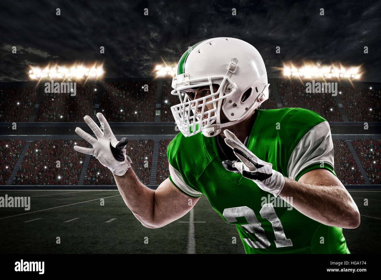 Football Player with a green uniform making a tackle on a stadium Stock ...