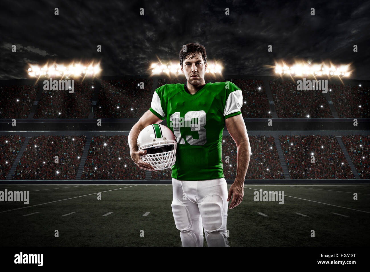 Football Player with a green uniform on a stadium Stock Photo - Alamy