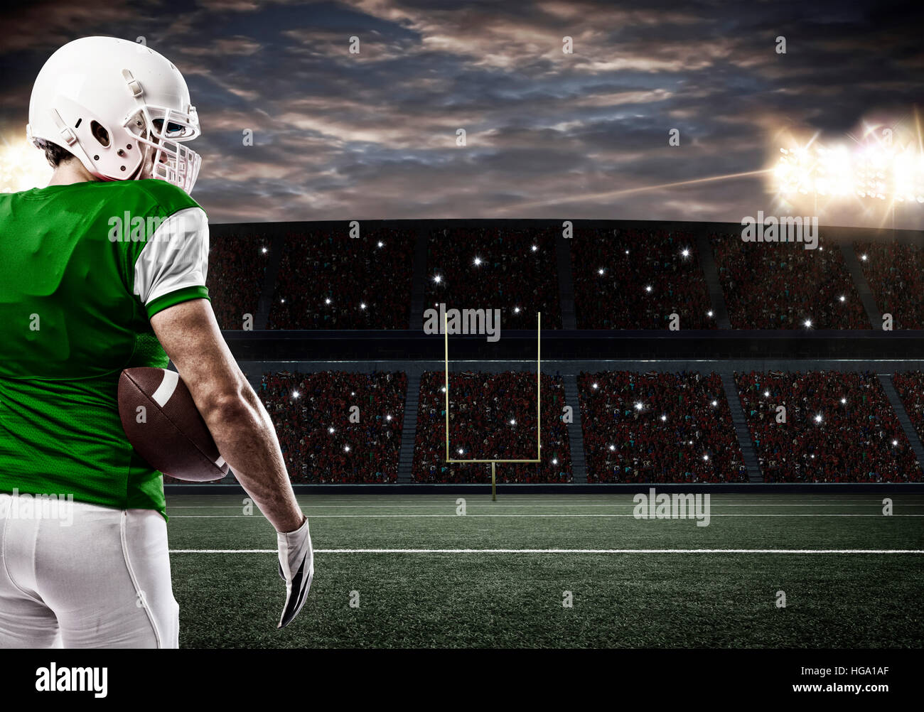Football Player with a green uniform on a stadium Stock Photo - Alamy