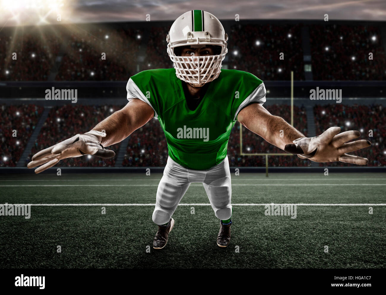 Football Player with a green uniform making a tackle on a stadium Stock ...