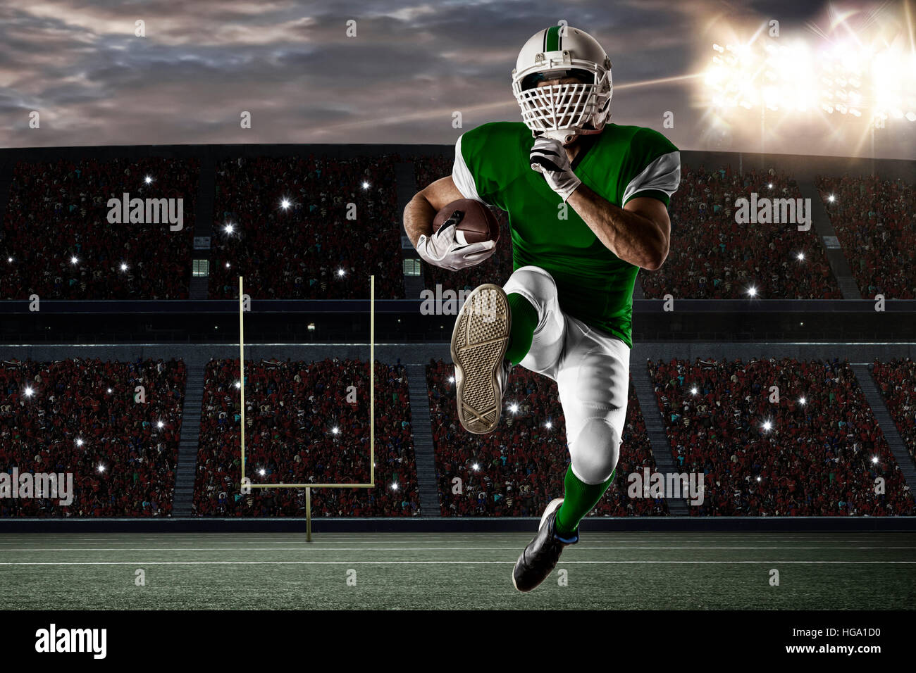 Football Player with a green uniform running on a stadium Stock Photo ...