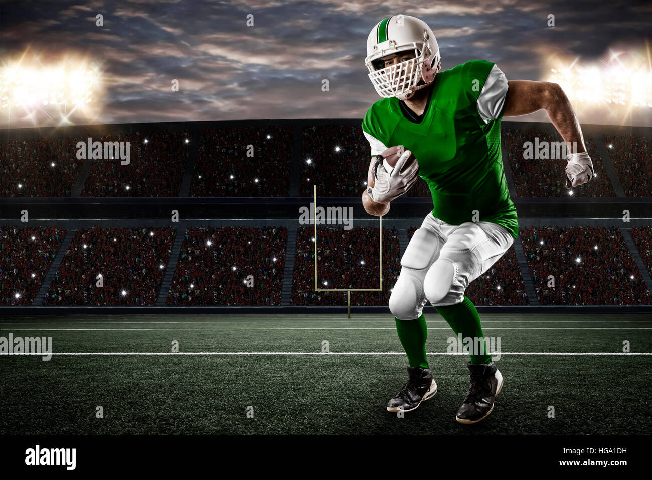 Football Player with a green uniform running on a stadium Stock Photo ...