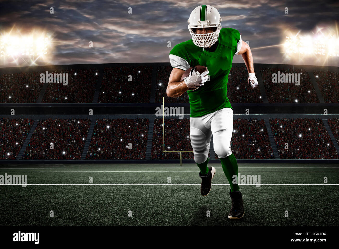 Football Player with a green uniform running on a stadium Stock Photo ...