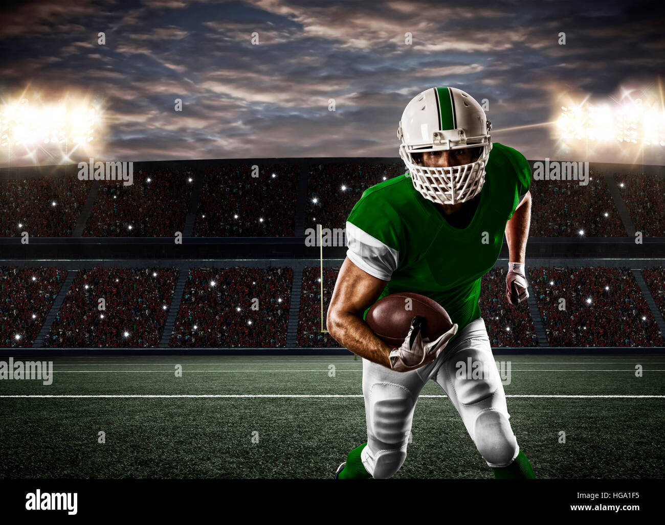 Football Player with a green uniform running on a stadium Stock Photo ...