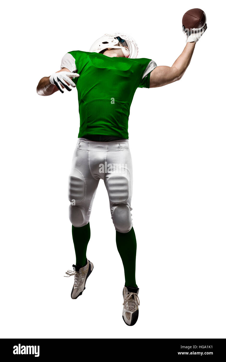 Football Player with a Green uniform making a catching on a white ...