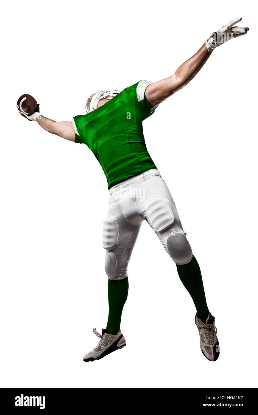 Football Player with a Green uniform making a catching on a white ...