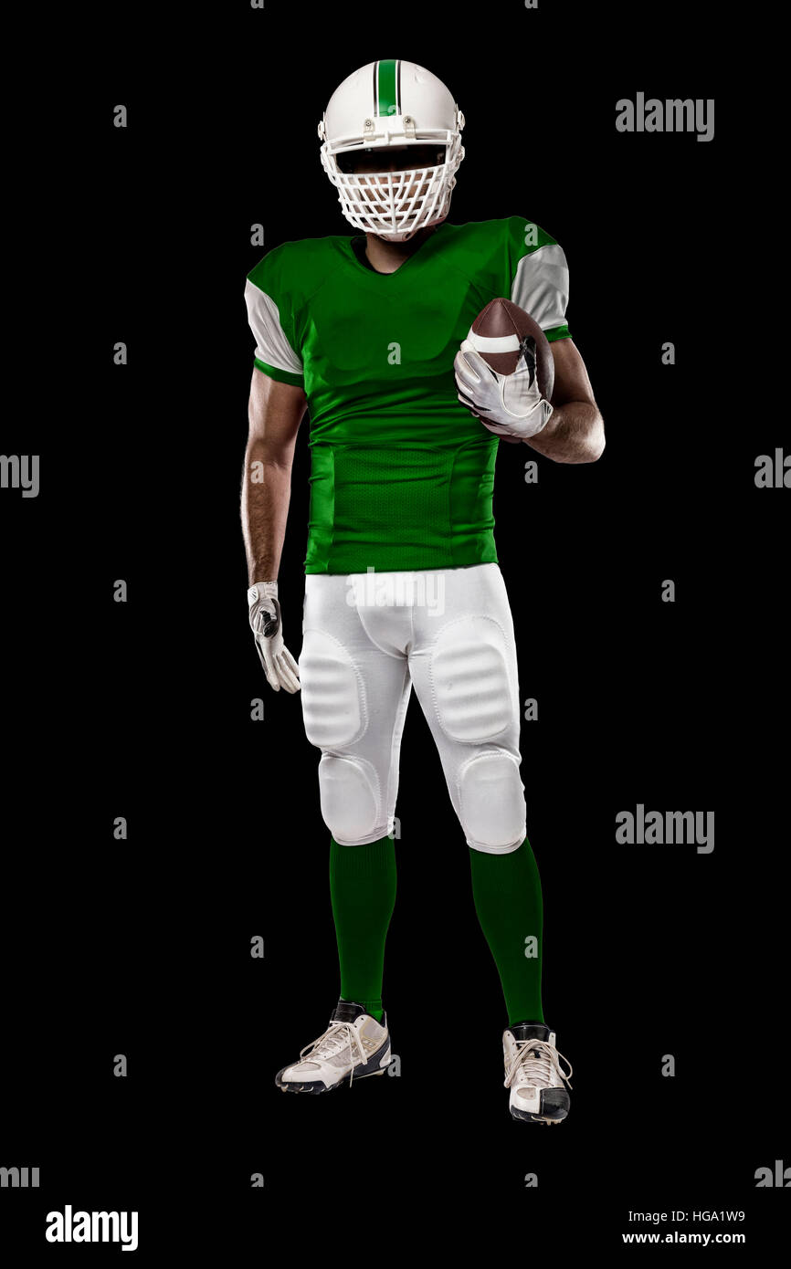 Football Player with a Green uniform on a black background Stock Photo ...