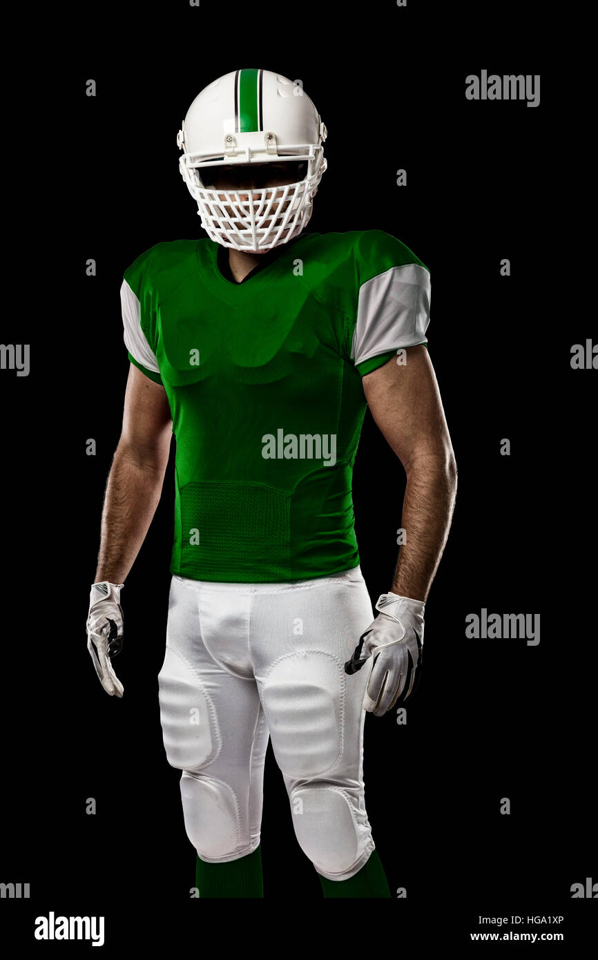 Football Player with a Green uniform on a black background Stock Photo ...