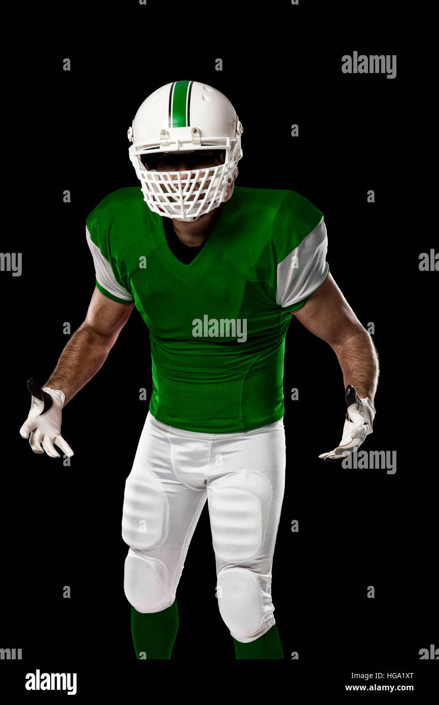 Football Player with a Green uniform on a black background Stock Photo ...
