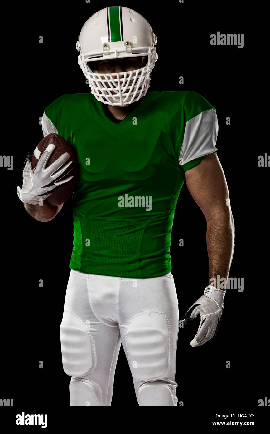 Football Player with a Green uniform on a black background Stock Photo ...
