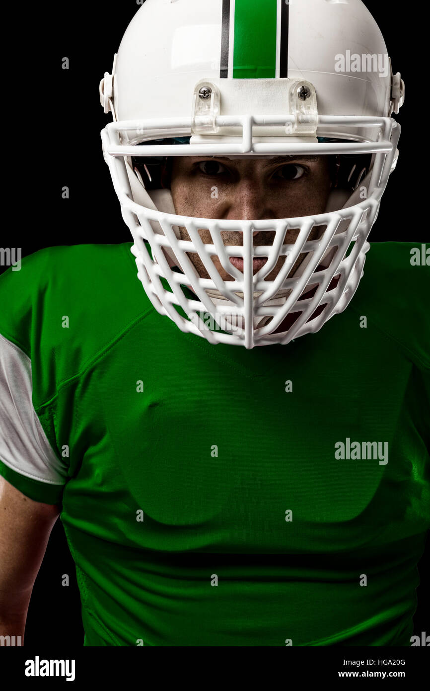Close up of a Football Player with a Green uniform on a black ...