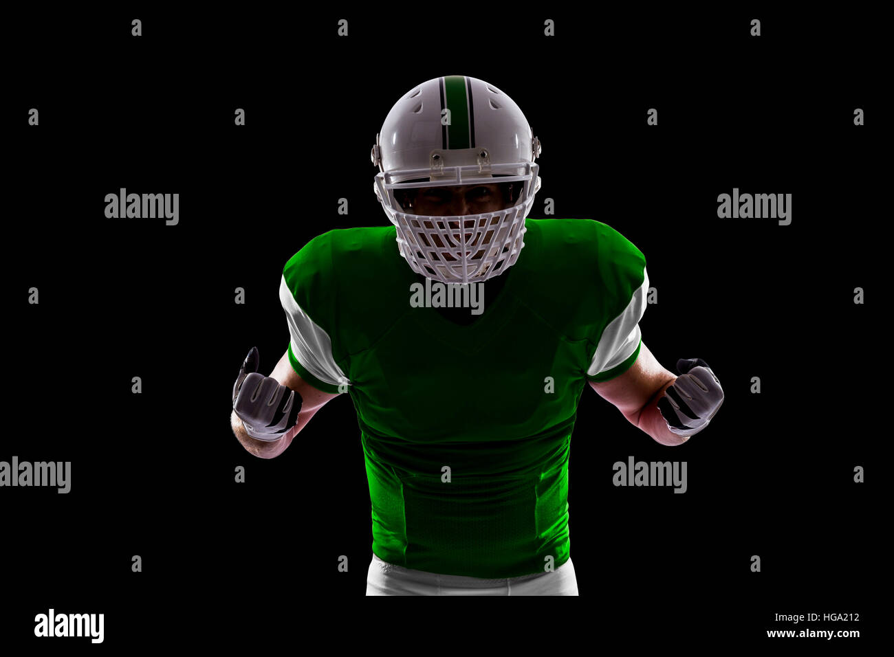 Football Player with a Green uniform on a black background Stock Photo ...