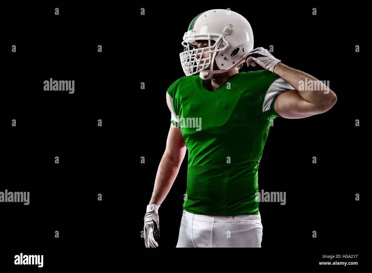 Football Player with a Green uniform on a black background Stock Photo ...