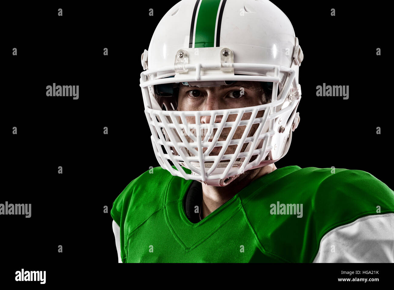 Close up of a Football Player with a Green uniform on a black ...