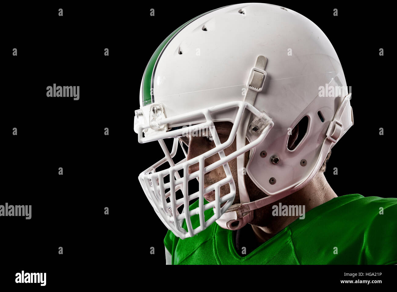 Close up of a Football Player with a Green uniform on a black ...