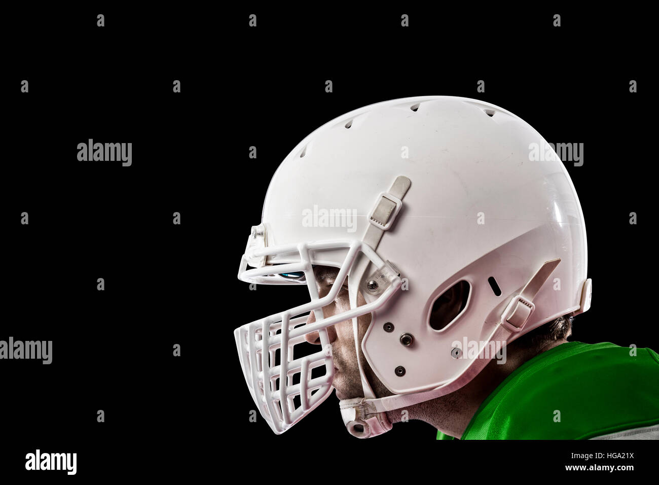 Close up of a Football Player with a Green uniform on a black ...
